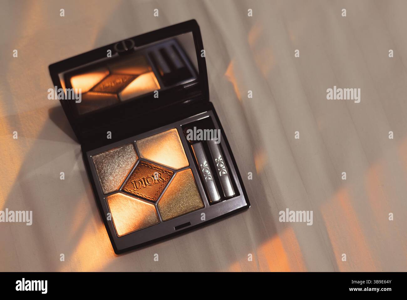 Paris, France 1 May 2025 A glamorous makeup palette Dior in a ray of ...