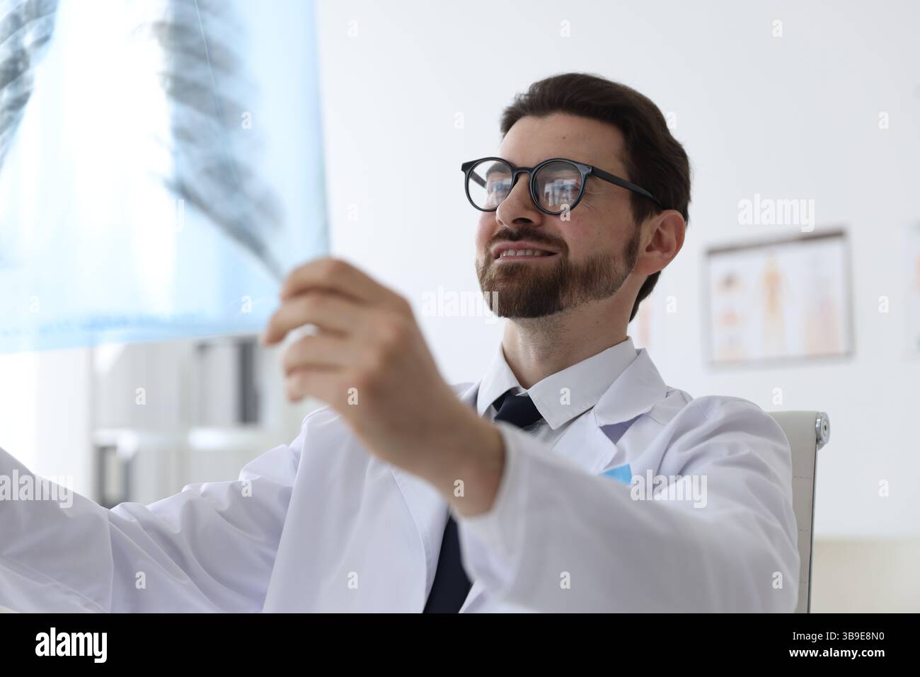Smiling doctor examining lung MRI scan in clinic Stock Photo - Alamy
