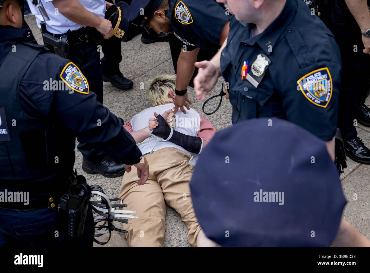 NEW YORK, NEW YORK - MAY 8: ??A ?protester? with a cast on their right ...