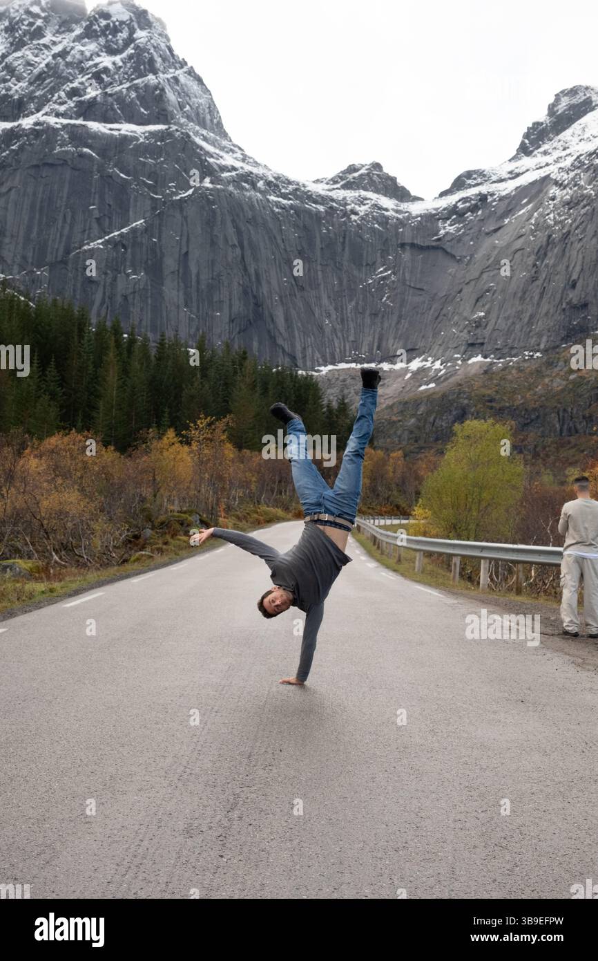 Person doing one armed handstand on Storvatnet Mountain also known as ...