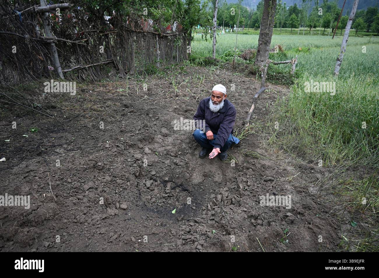 URI, INDIA - MAY 9: A man shows crater formed by Pakistani artillery ...