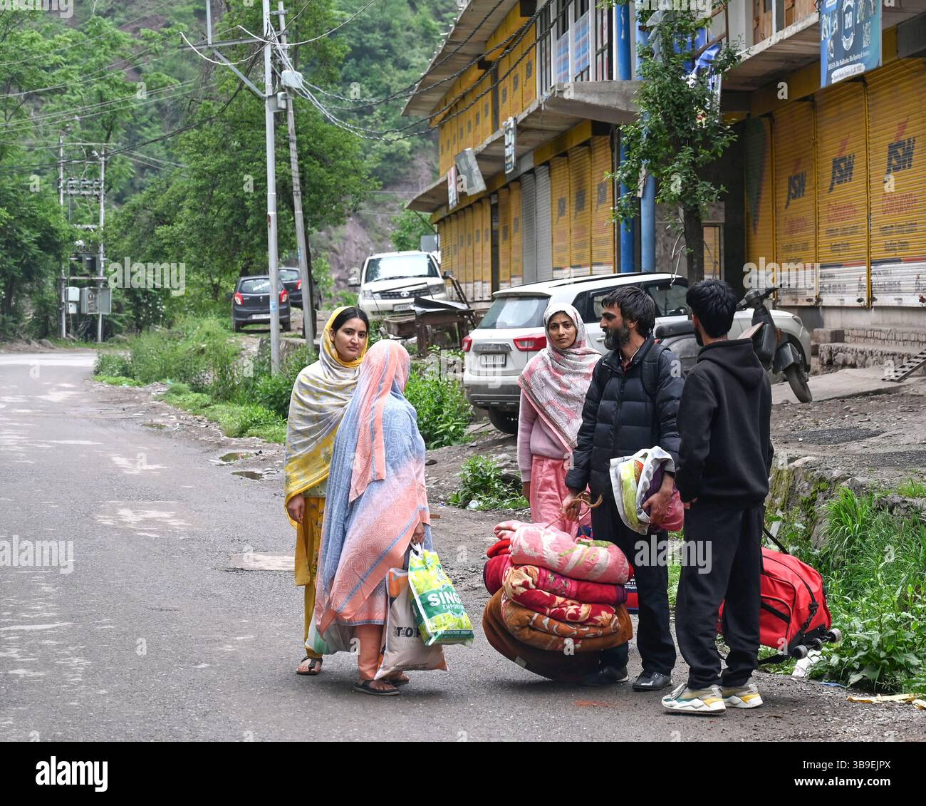 URI, INDIA - MAY 9: People leave their homes after overnight artillery ...