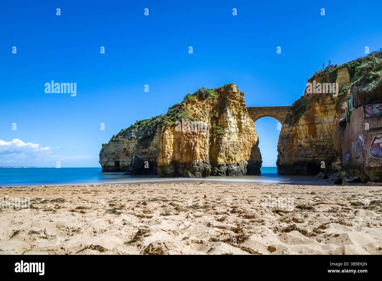 A seaside bay over which the old stone bridge of the Pinhao Fort ...