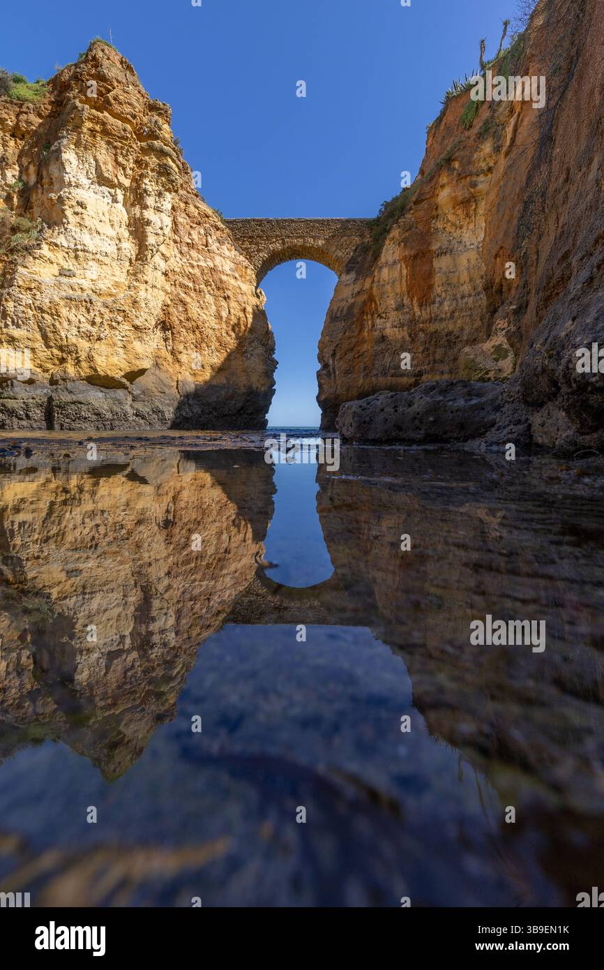 A seaside bay over which the old stone bridge of the Pinhao Fort ...