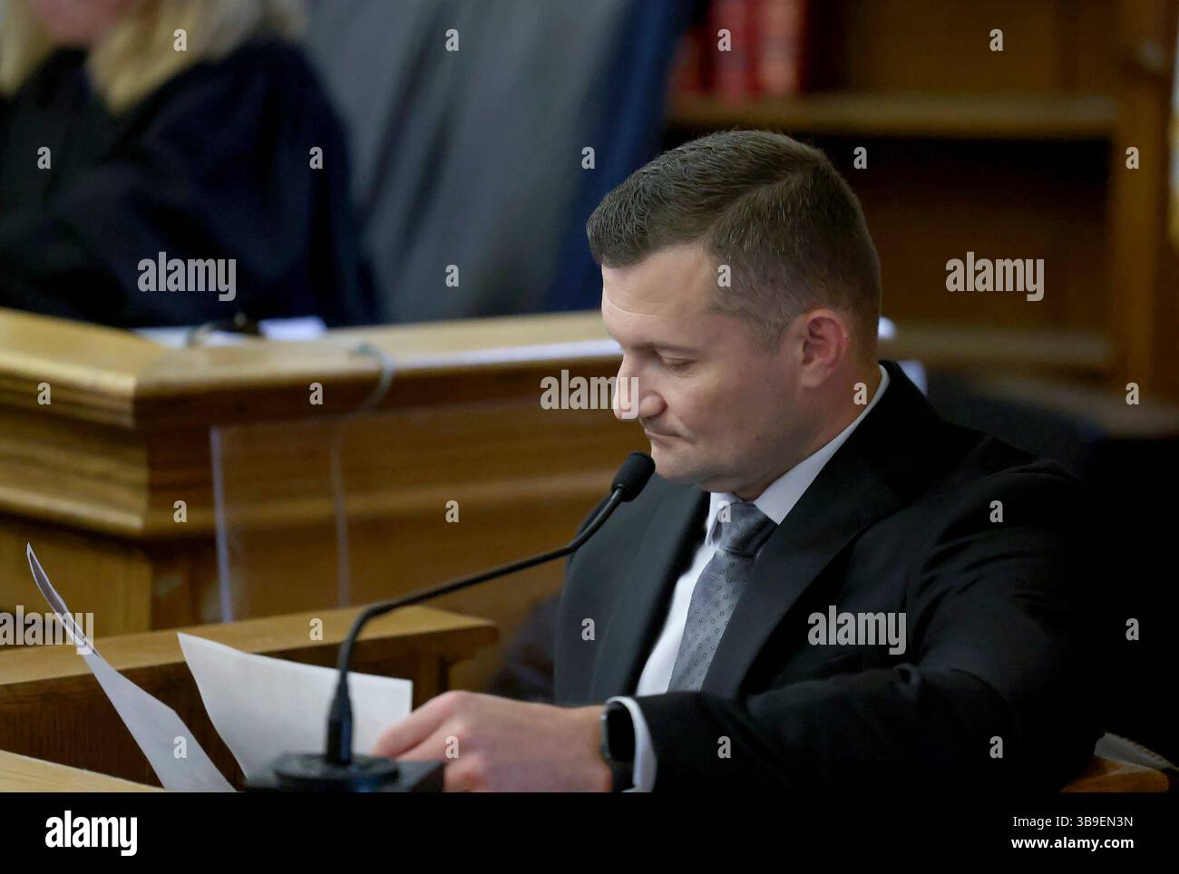 Massachusetts State Police Sgt. Yuriy Bukhenik looks over documents ...