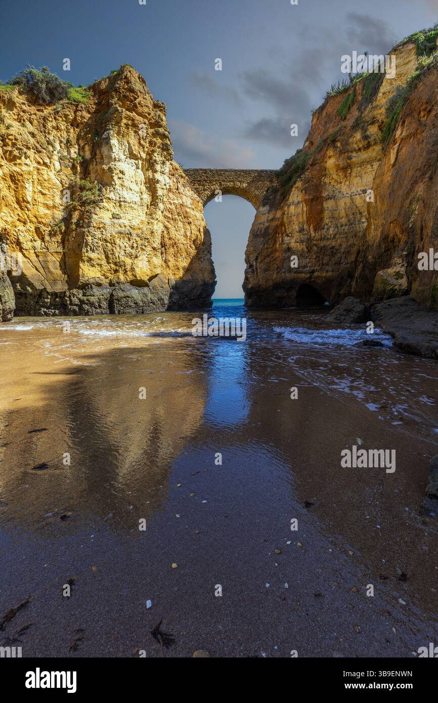 A seaside bay over which the old stone bridge of the Pinhao Fort ...