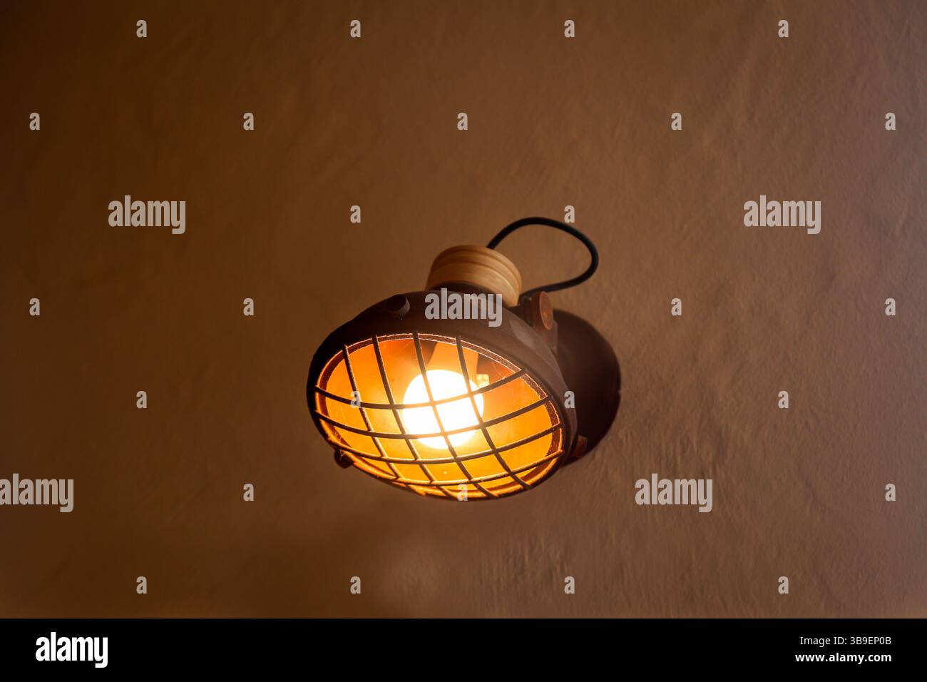 A spotlight-like lamp fixed to a house wall Stock Photo - Alamy