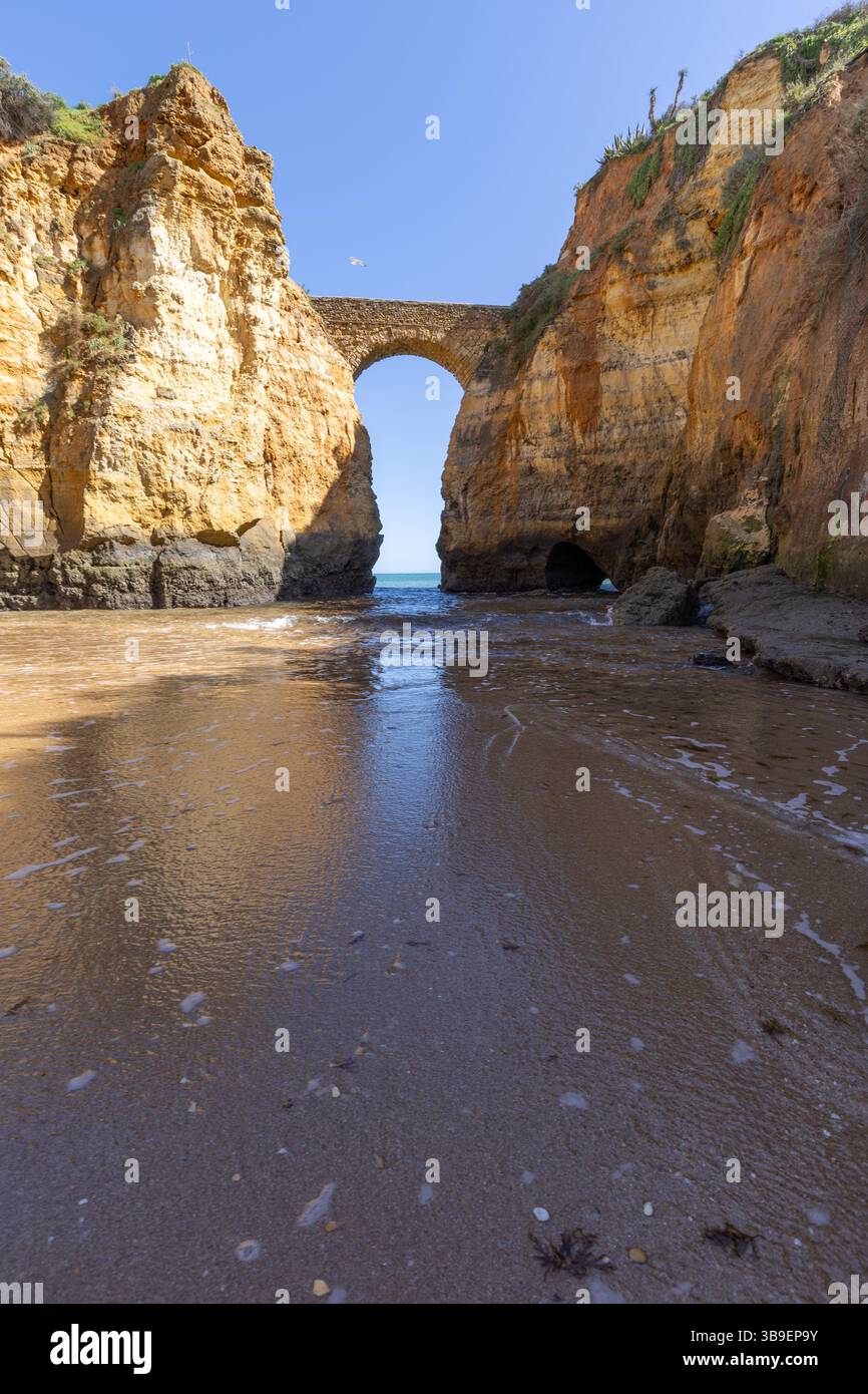 A seaside bay over which the old stone bridge of the Pinhao Fort ...