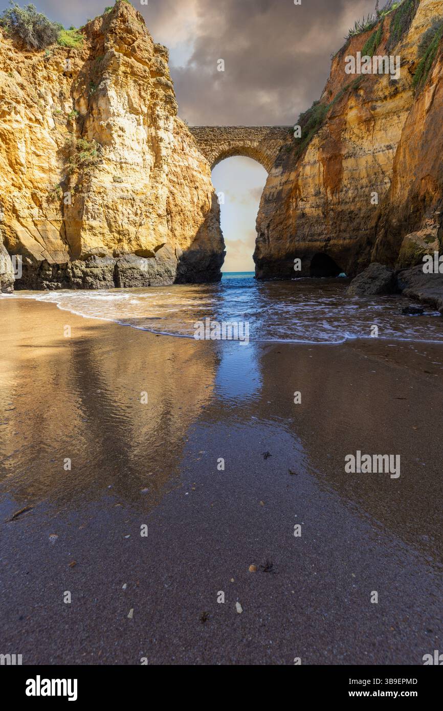 A seaside bay over which the old stone bridge of the Pinhao Fort ...