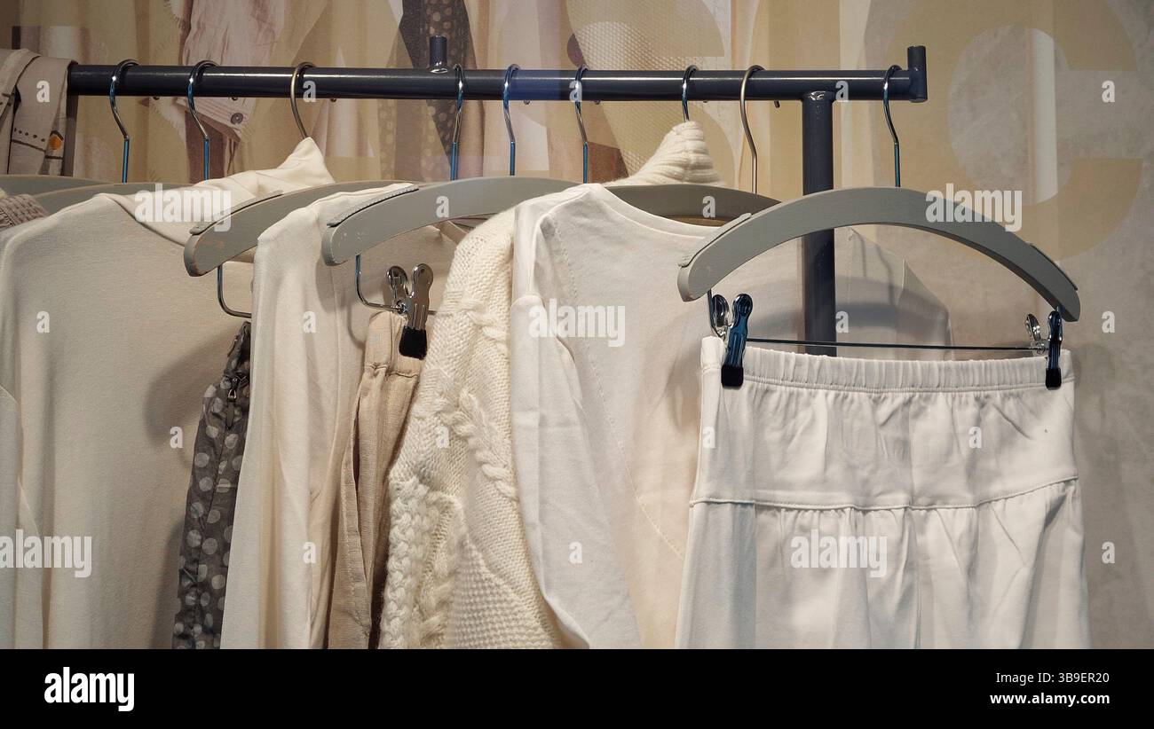 Bright women's clothes on hangers on clothes rail Stock Photo - Alamy