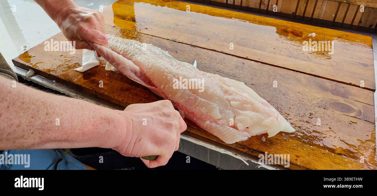 Peeling off the fish skin Stock Photo - Alamy