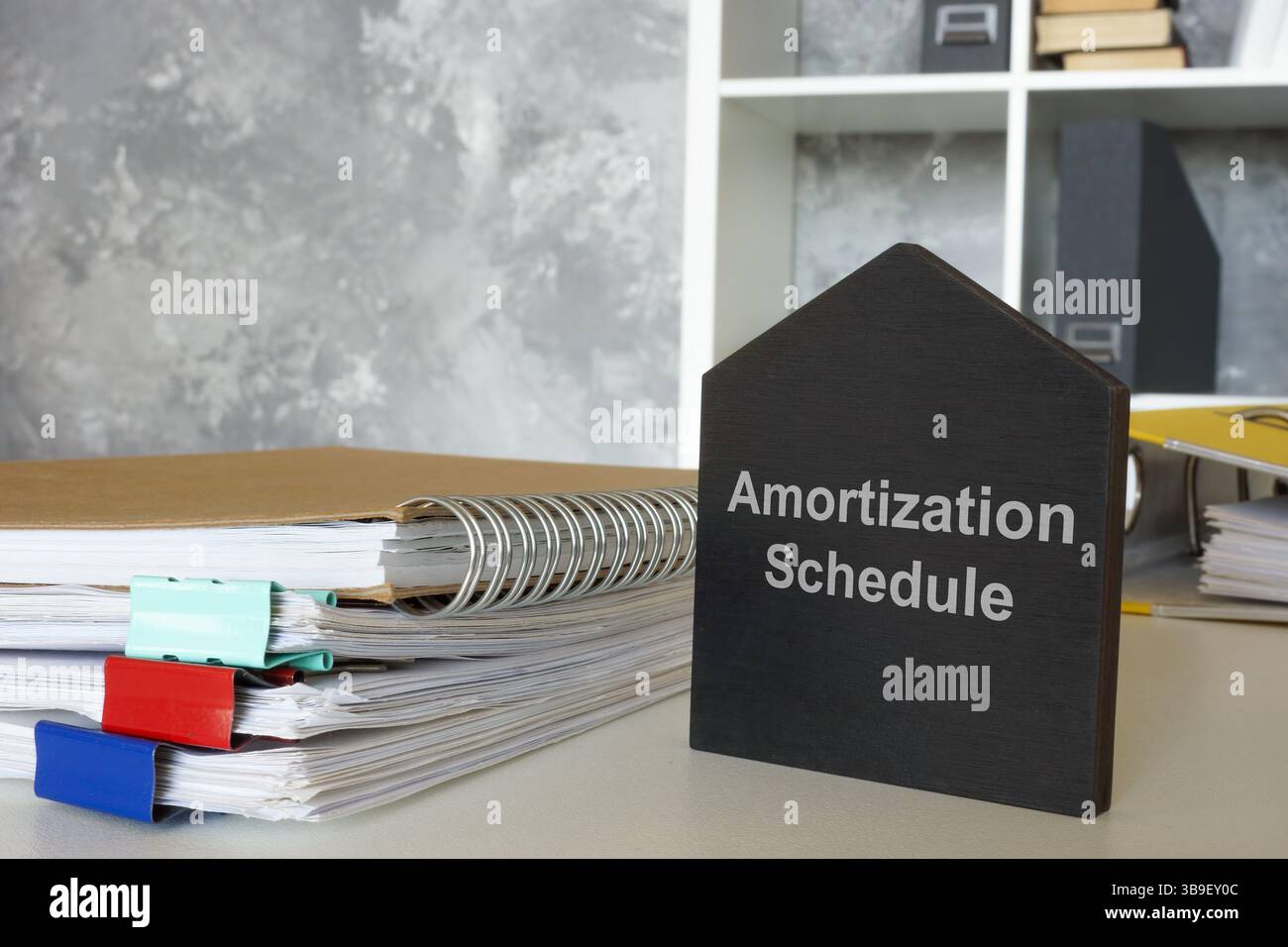 Amortization schedule and stack of documents. Debt repayment planning ...