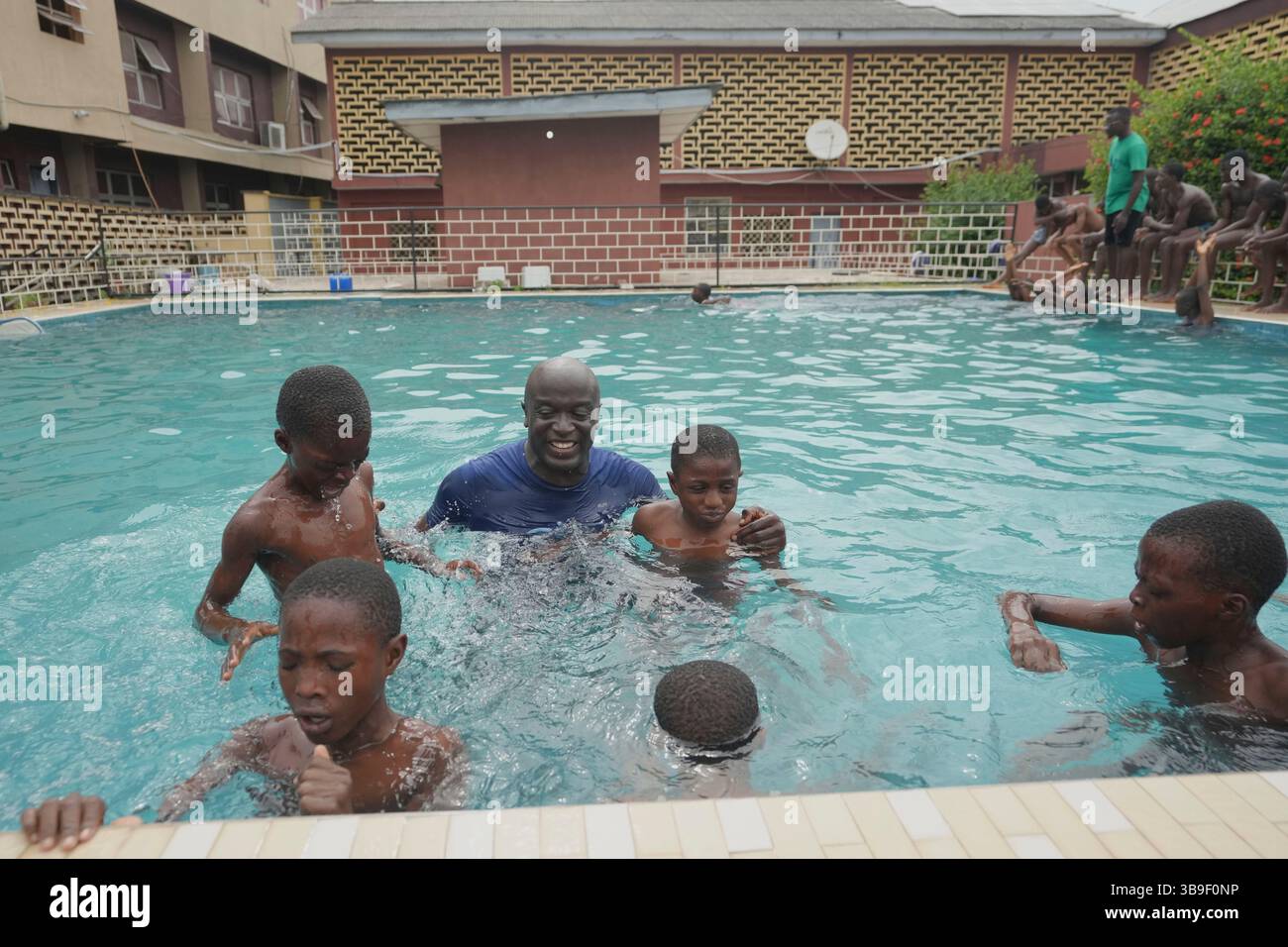 Swimming coach Emeka Chuks Nnadi teaches young, disabled students to swim as part of his Swim in ...