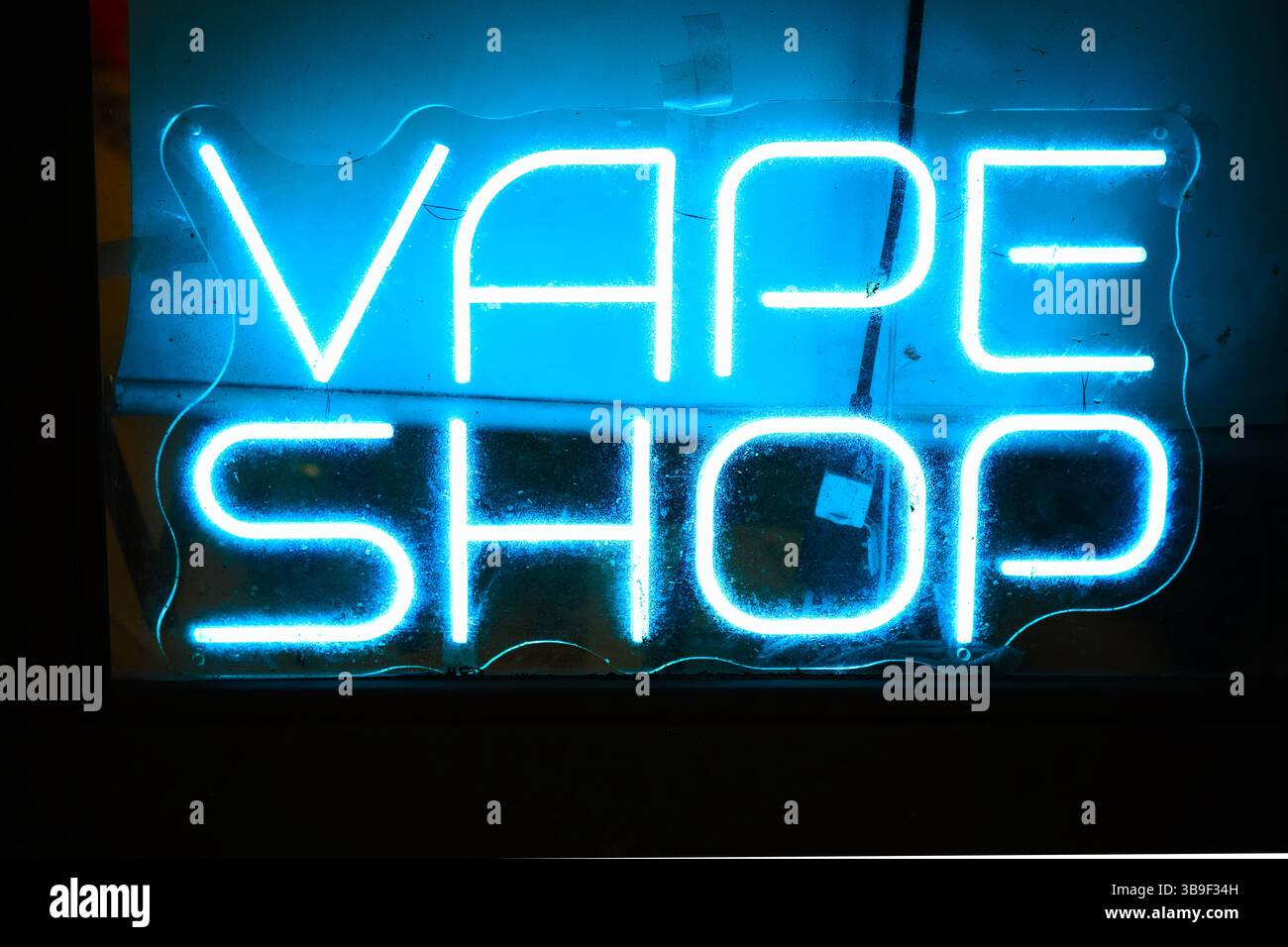 Neon blue Vape Shop sign in smoke shop window Stock Photo - Alamy