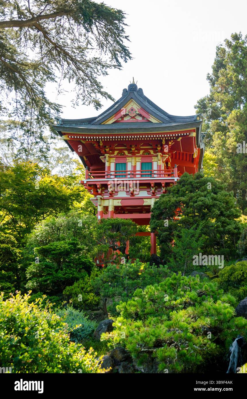 Pagoda behind trees and bushes Stock Photo - Alamy