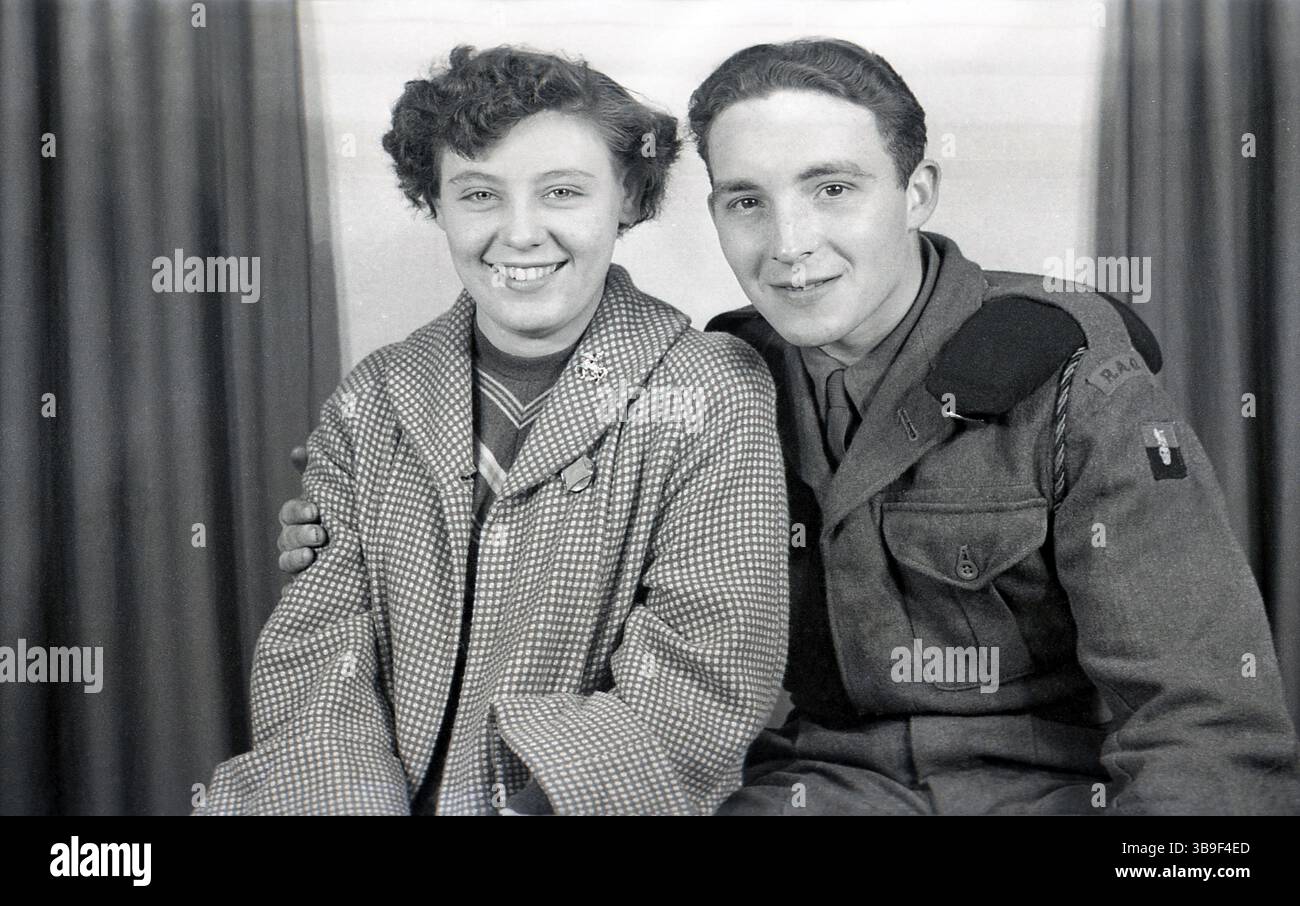 1950s, historical, in a photographic studio, infront of a curtain ...