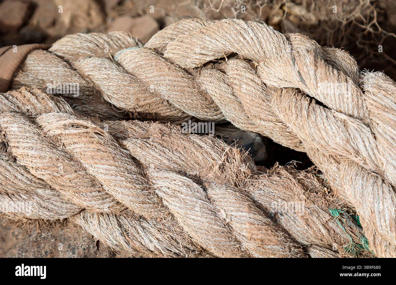 A carelessly thrown away old rope from a cutter, a ship Stock Photo - Alamy