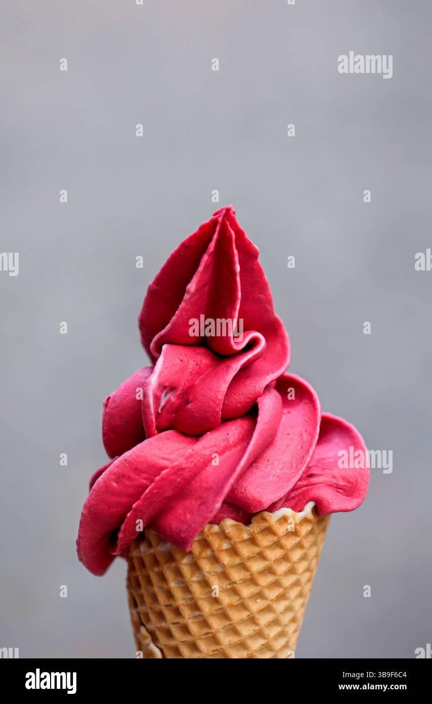 One waffle cone with raspberry soft ice cream hi-res stock photography ...