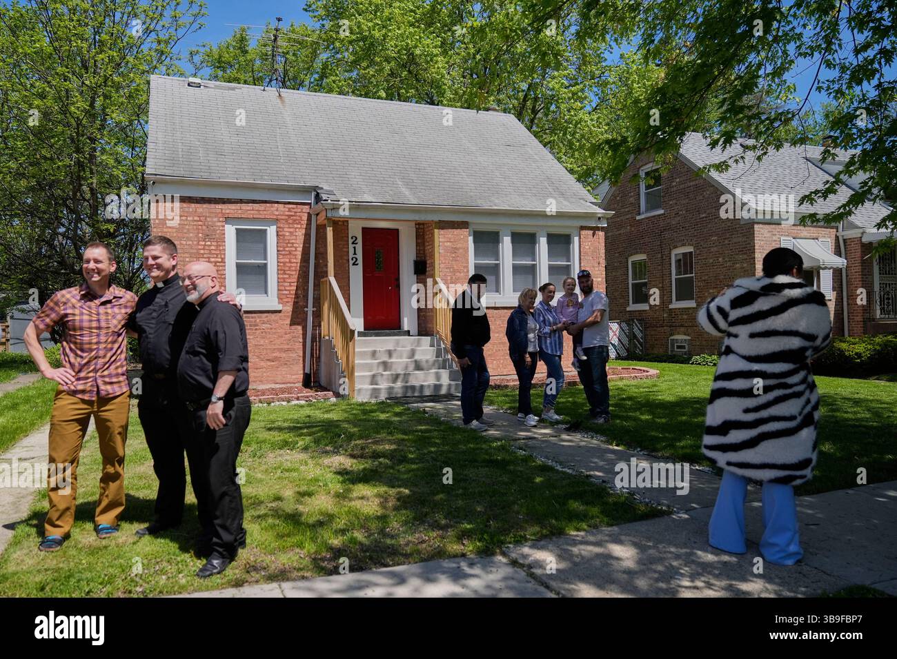 People take photos in front of Pope Leo XIV's childhood home Friday, May 9, 2025, in Dolton, Ill ...