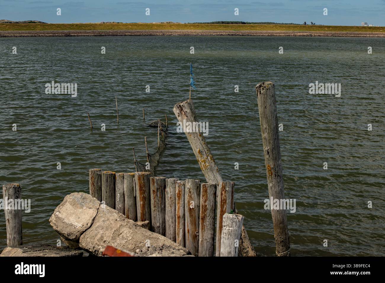 Fishing net (eel trap) on a breakwater with rubble Stock Photo - Alamy