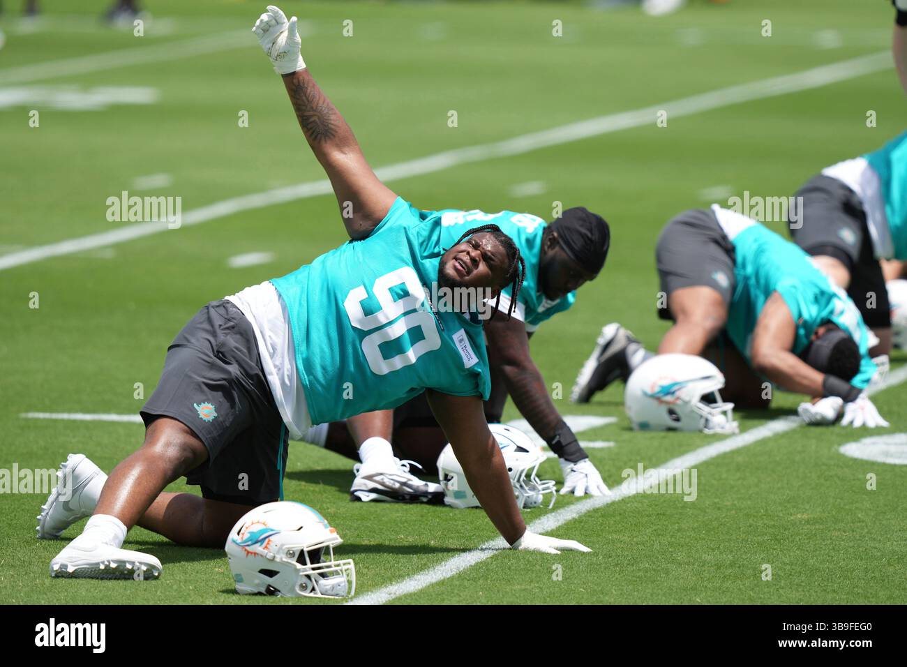 Miami Dolphins defensive tackle Kenneth Grant (90) stretches during the ...