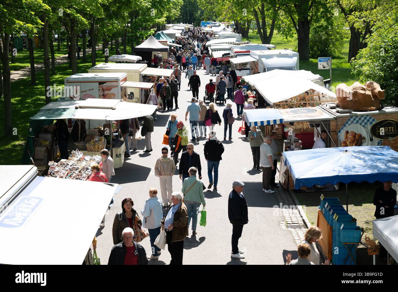 Dresden, Germany. 09th May, 2025. People walk between stalls at Lingnermarkt. Credit: Sebastian ...