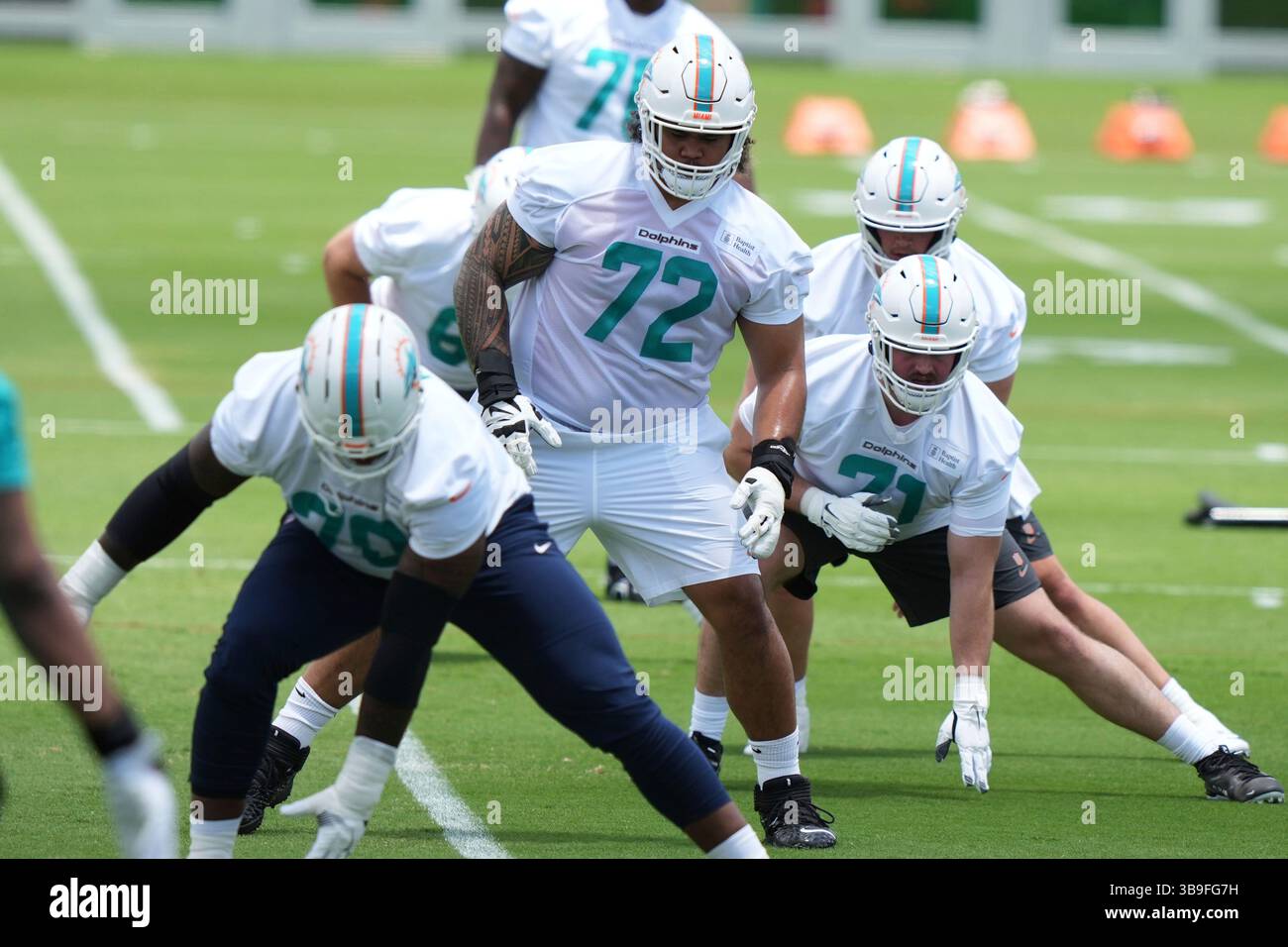 Miami Dolphins offensive lineman Jonah Savaiinaea (72) does drills during the NFL football team ...