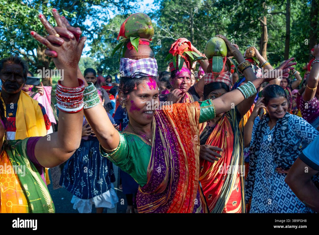 With faces powdered and carrying coconuts on their heads, women ...
