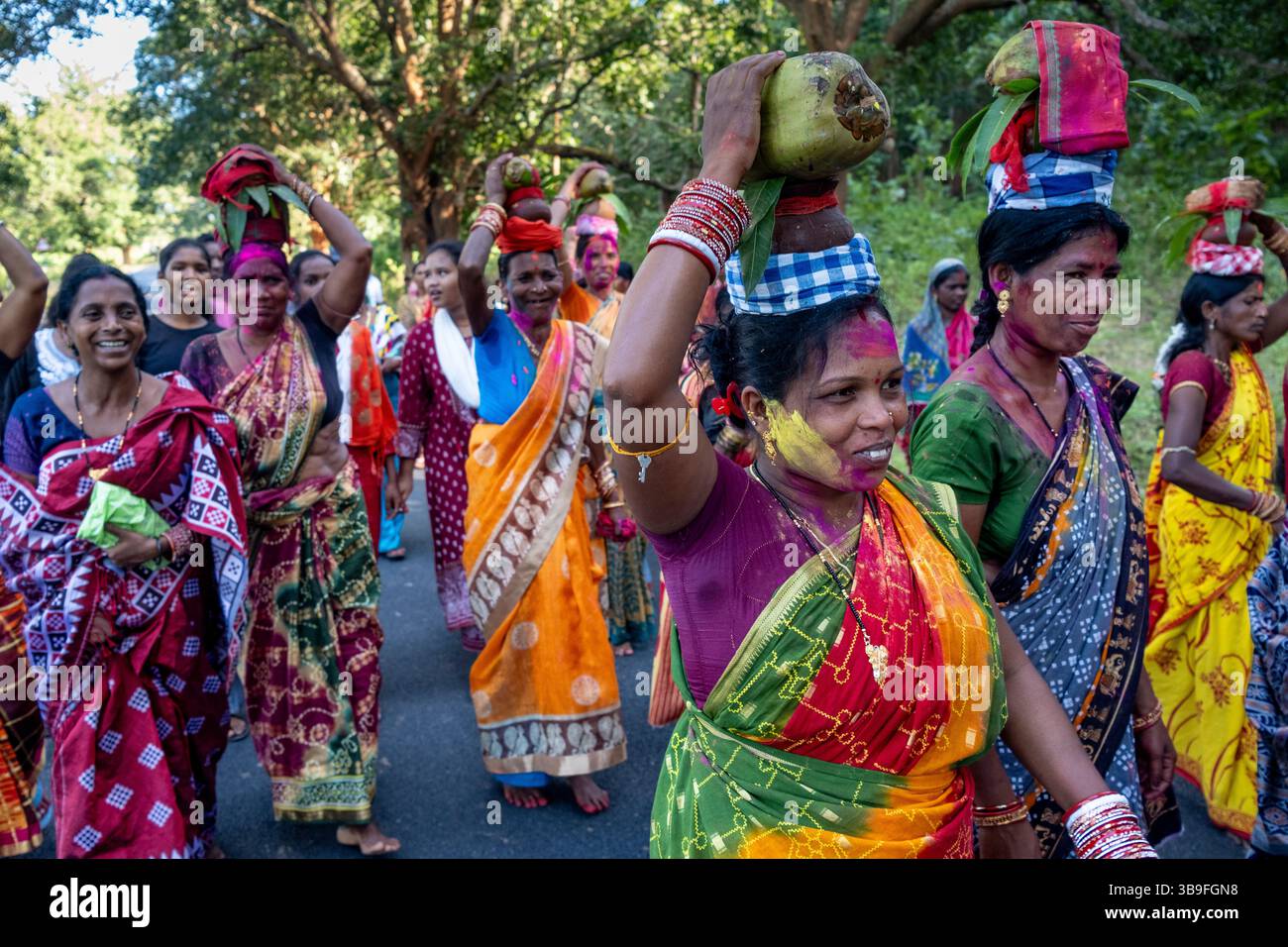With faces powdered and carrying coconuts on their heads, women ...
