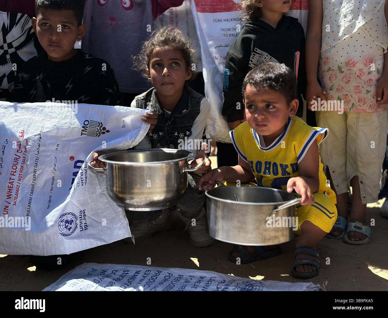 A large crowd, including children, gather, leading to chaotic scenes as ...