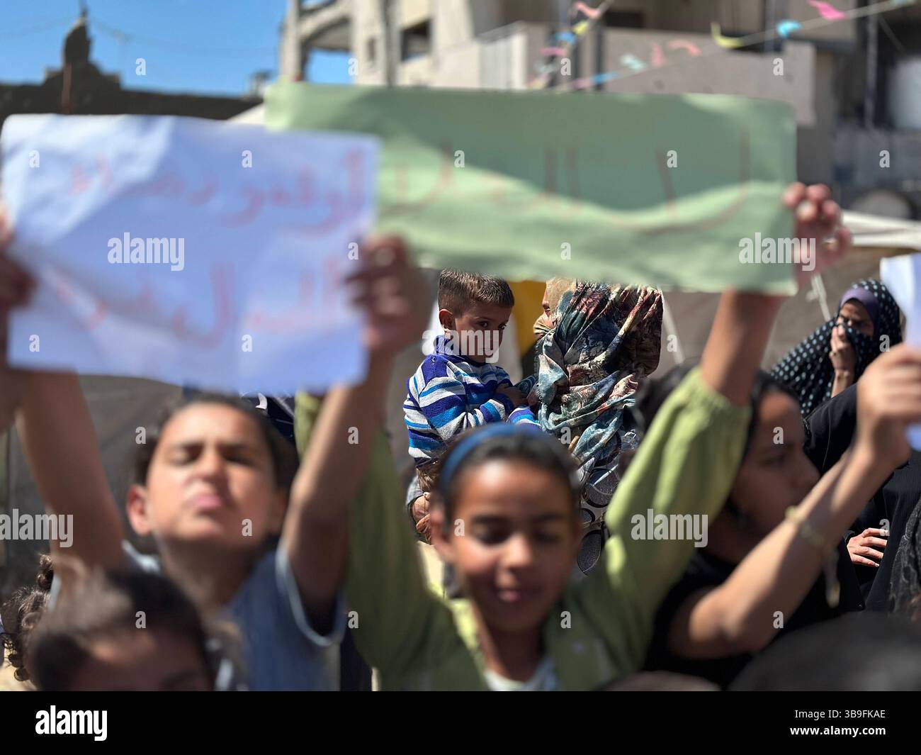 A large crowd, including children, gather, leading to chaotic scenes as ...