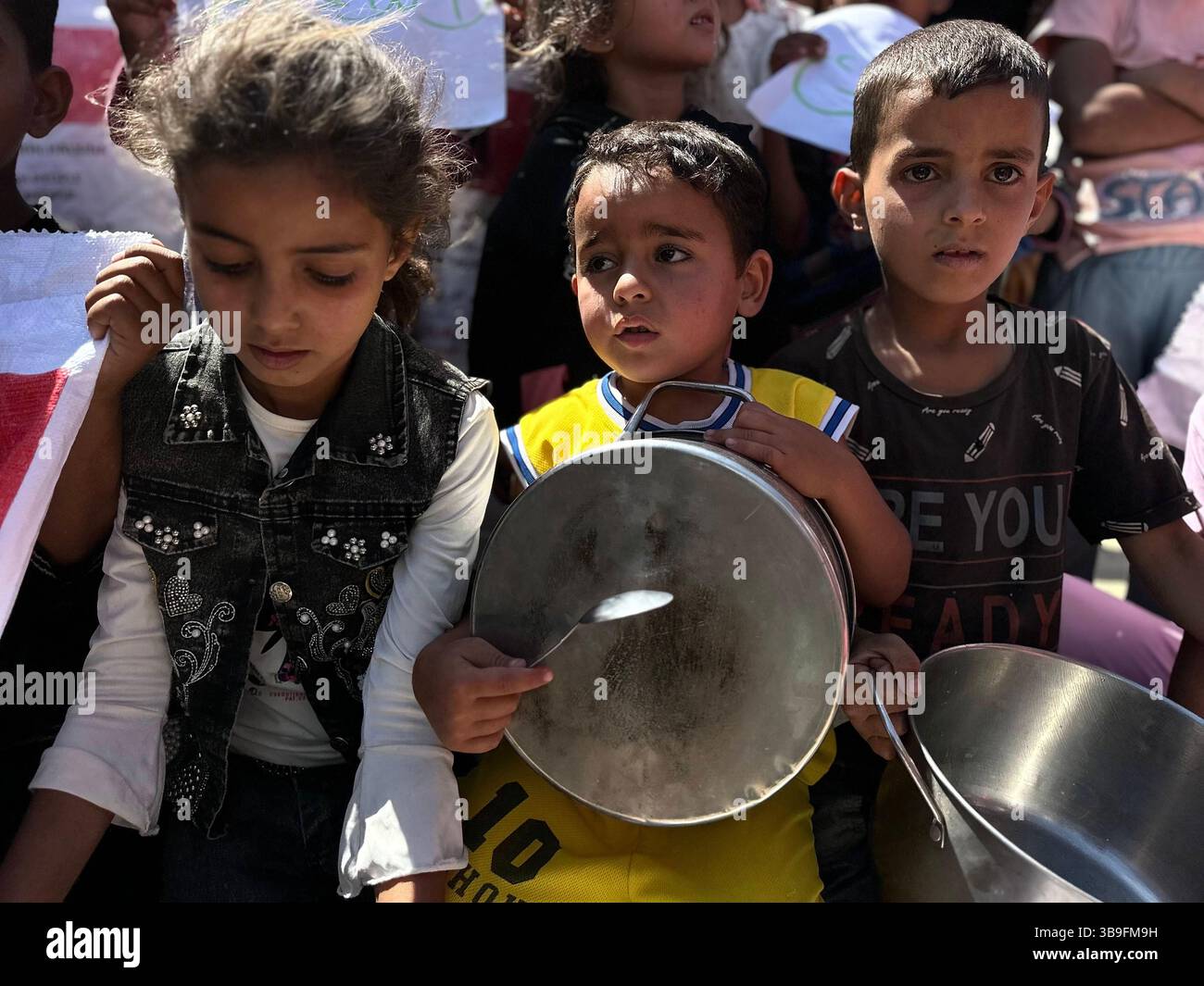 A large crowd, including children, gather, leading to chaotic scenes as ...