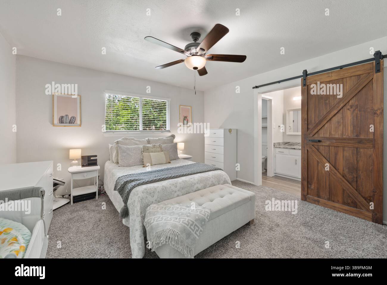 A cozy bedroom featuring a stylish ceiling fan for comfort and a modern ...