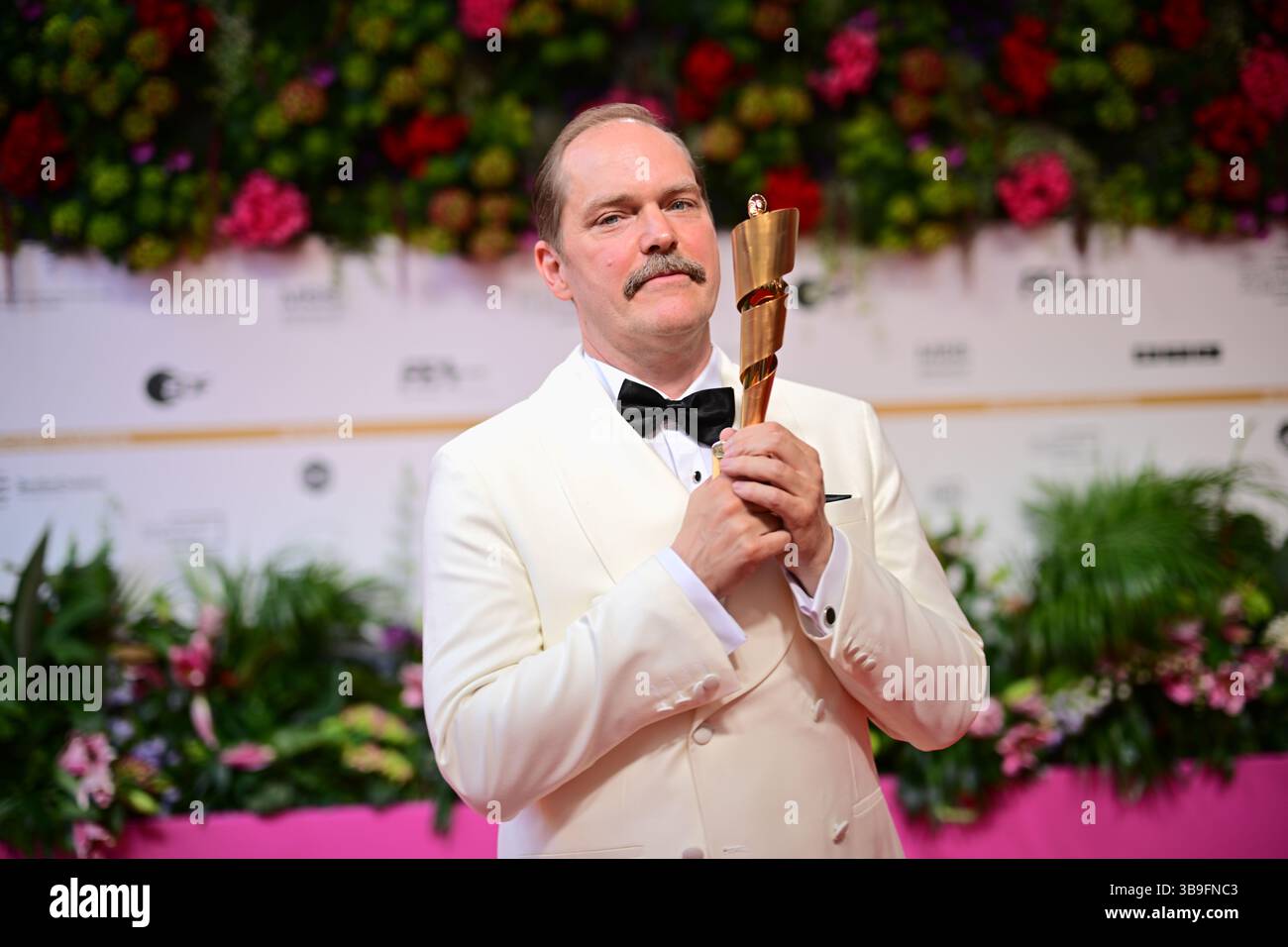 Berlin, Germany. 09th May, 2025. Actor Godehard Giese, holds the Lola ...