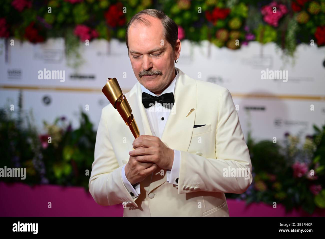 Berlin, Germany. 09th May, 2025. Actor Godehard Giese, holds the Lola ...