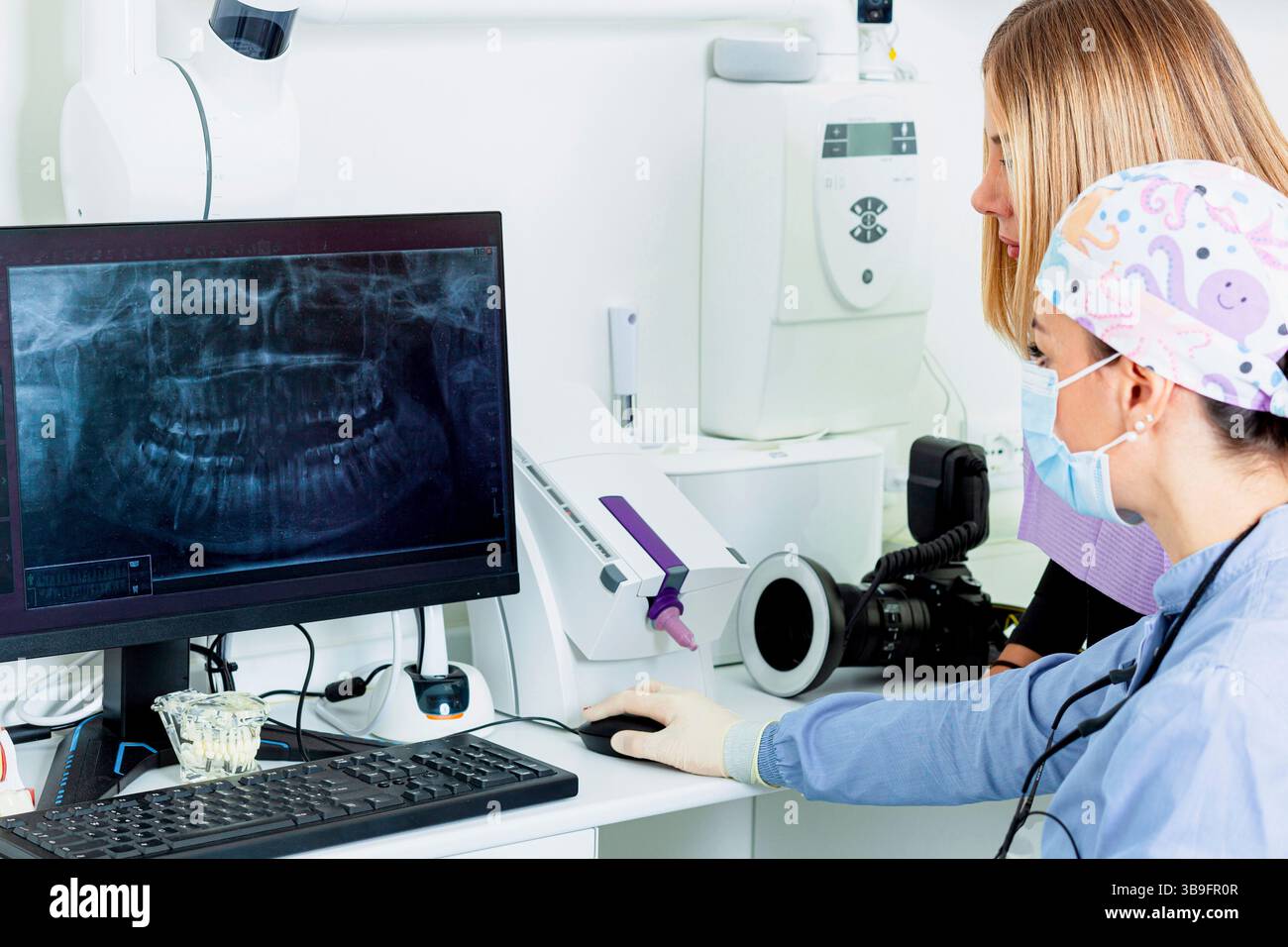 Dentist analyzing radiography on computer hi-res stock photography and ...