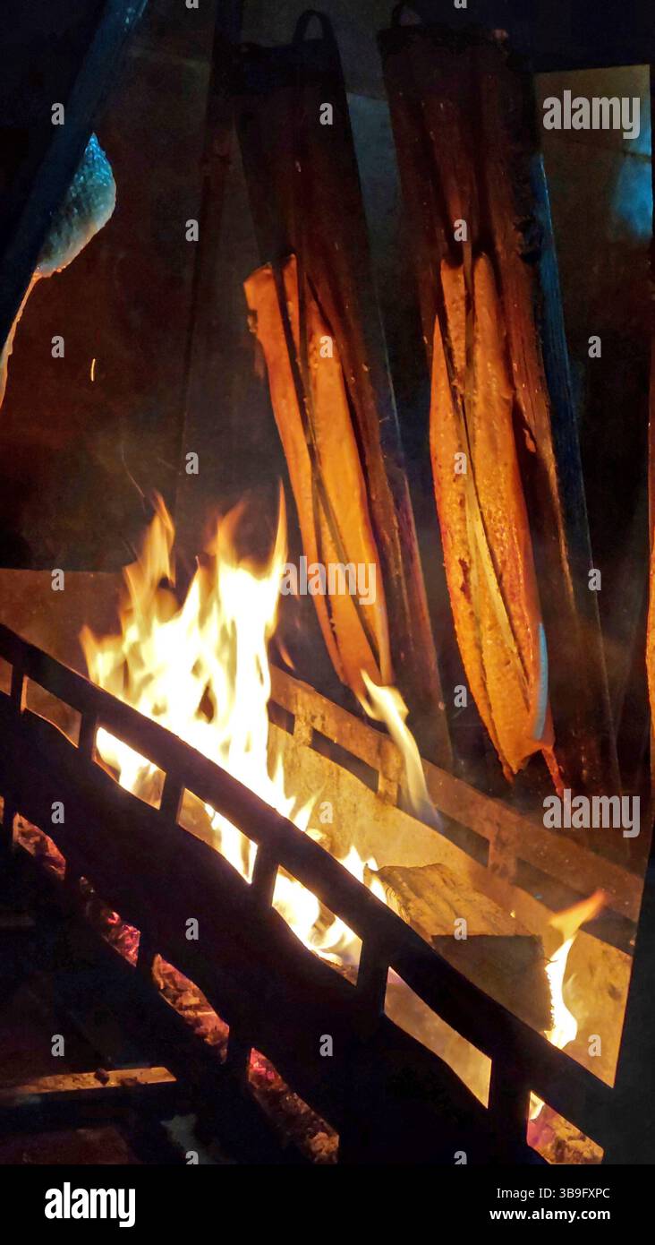 Open fire with flaming salmon Stock Photo - Alamy