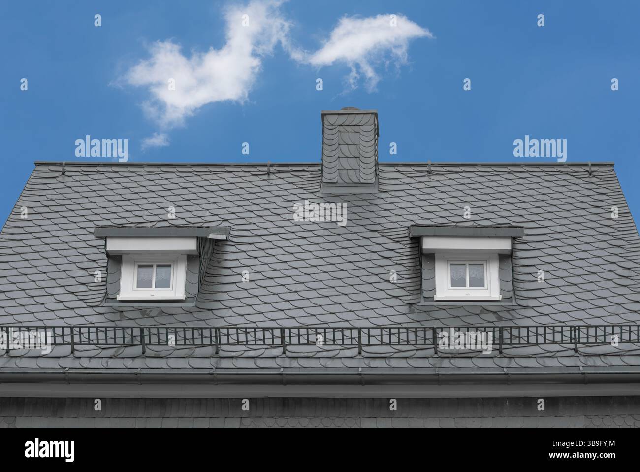 Slate roof with two windows and chimney Stock Photo - Alamy