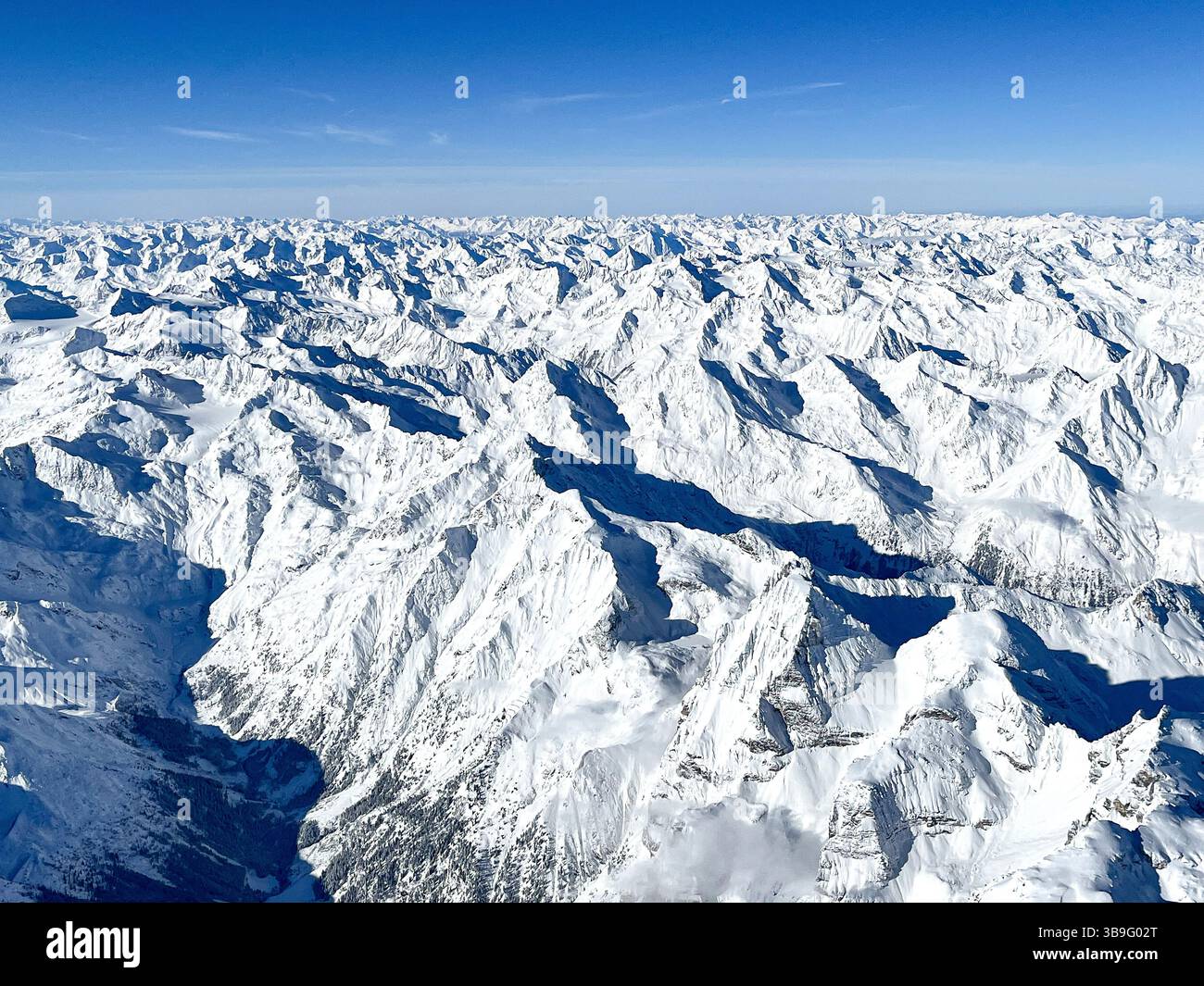 Sea of peaks from a great height Aerial view of the main Alpine ridge ...