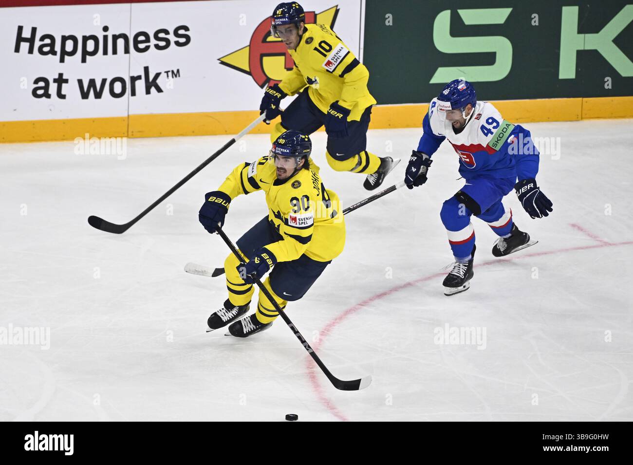 Sweden's Marcus Johansson (90) skates with the puck as teammate ...