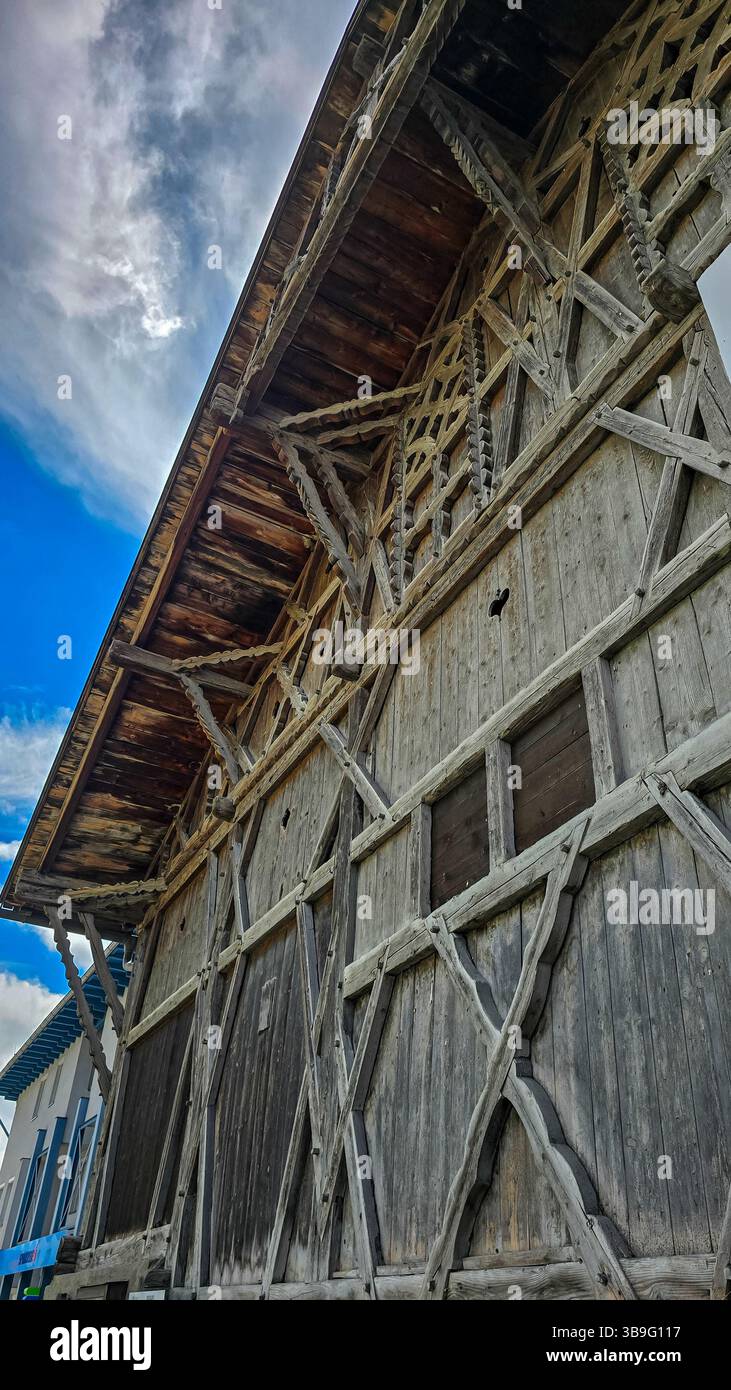 A fragment of a traditional Austrian wooden house against a blue sky ...