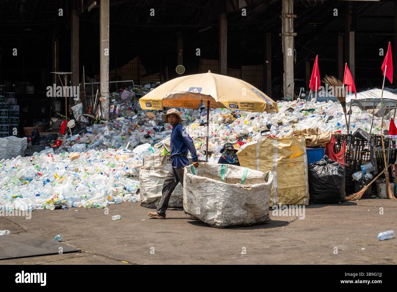 May 9, 2025, Bangkok, Thailand: In a local warehouse, a waste-sorting ...