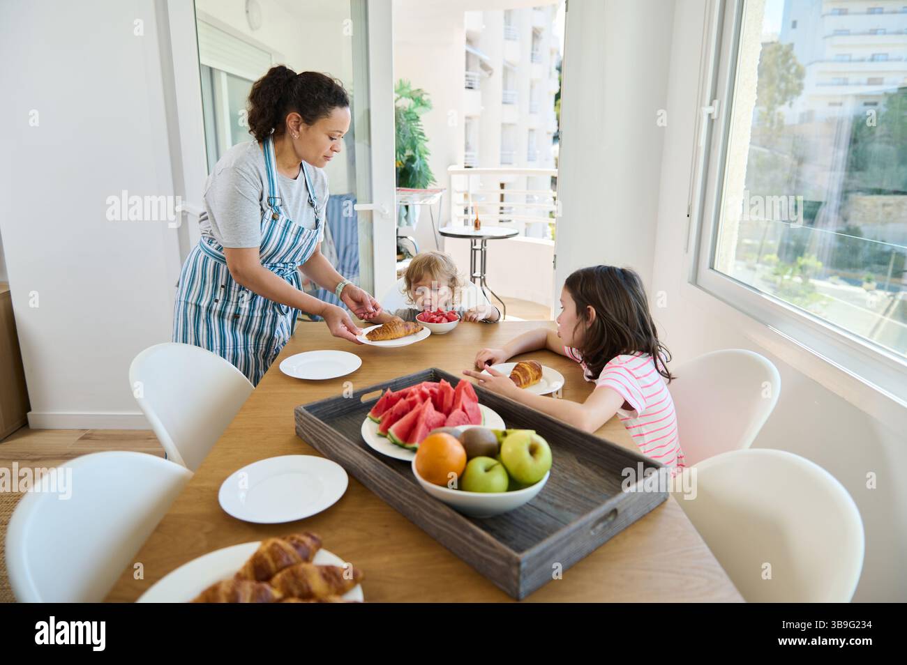 A loving family sharing breakfast in their cozy and modern home ...
