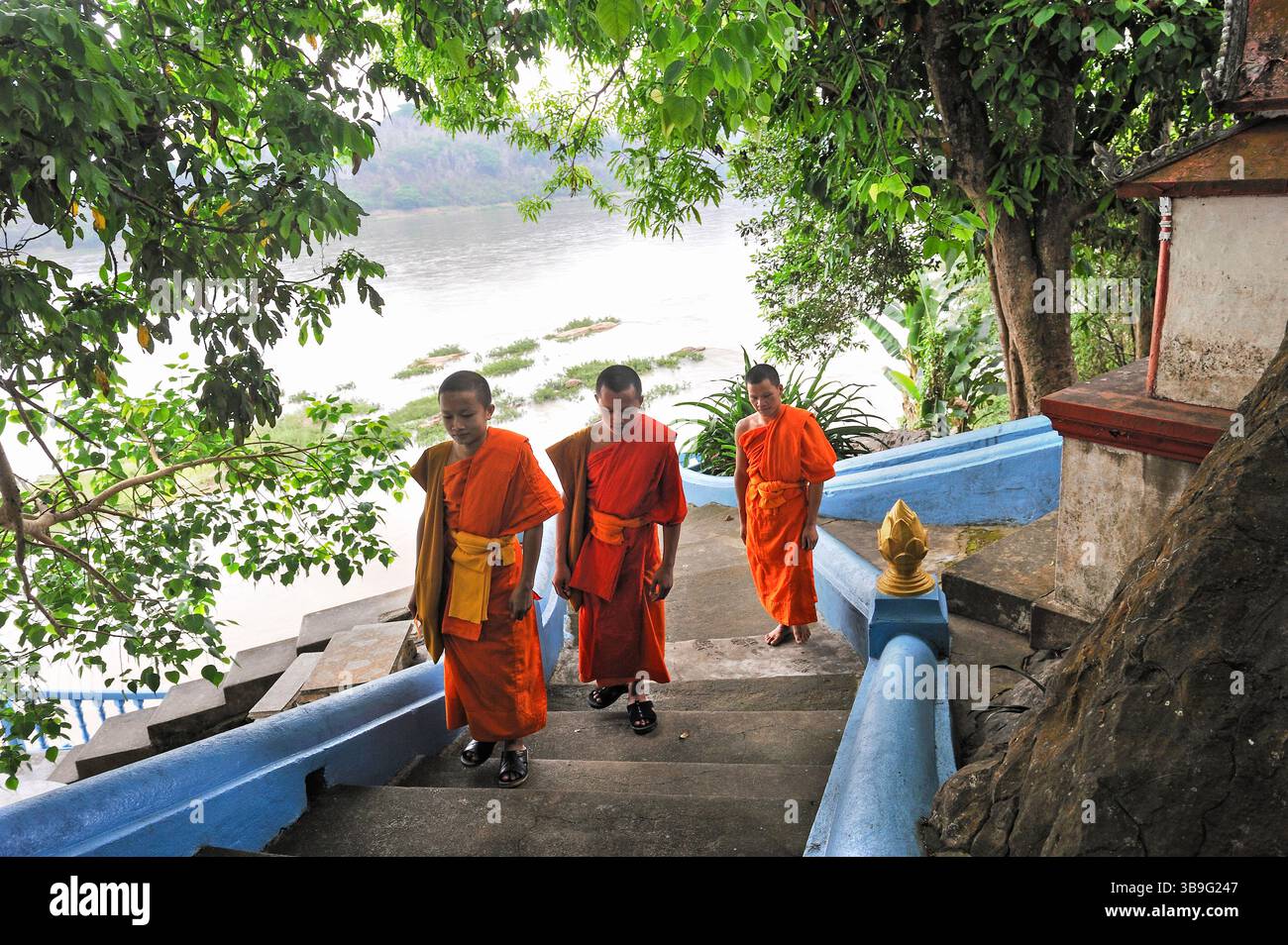 Novice monks on stairs leading to a huge footprint of the Buddha by the ...