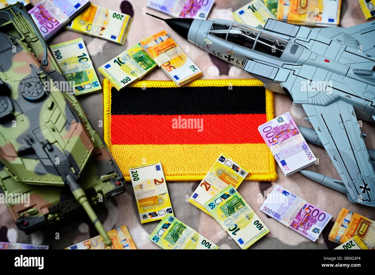 German flag with banknotes, tank and military jet, symbolic photo of ...