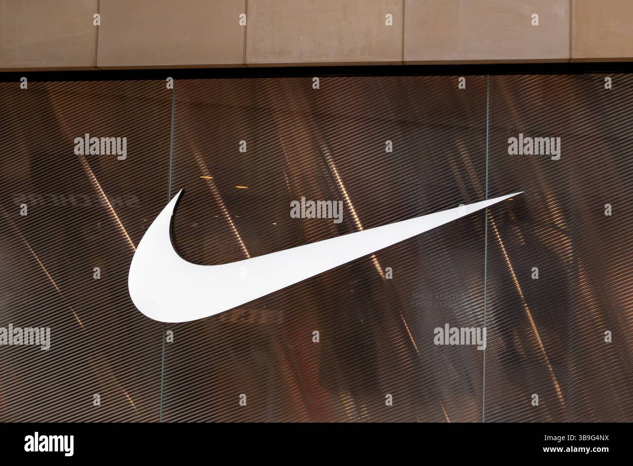 A large, white Nike swoosh logo is prominently displayed against a ...