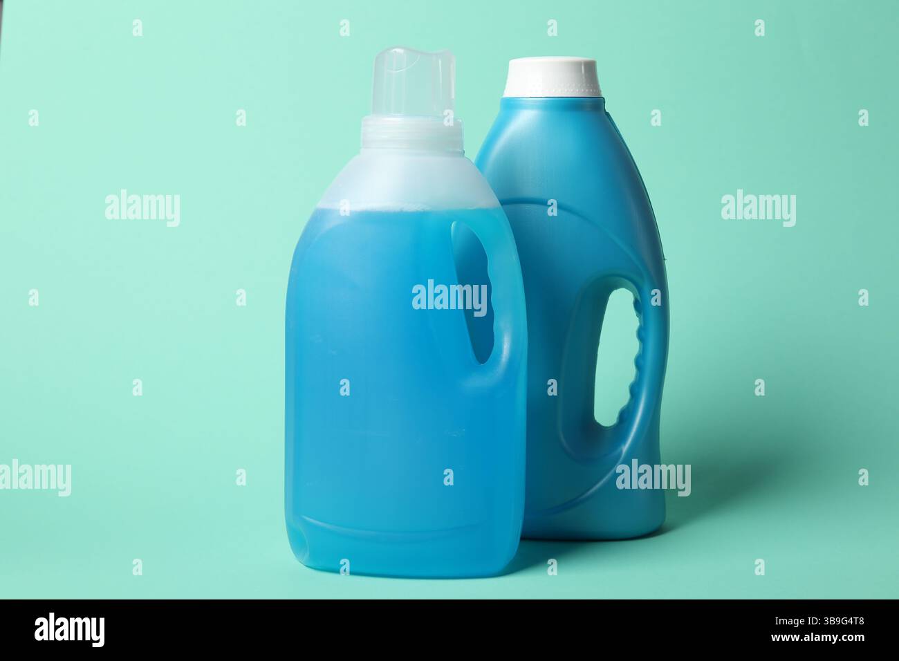 Bottles of fabric softener on turquoise background Stock Photo - Alamy