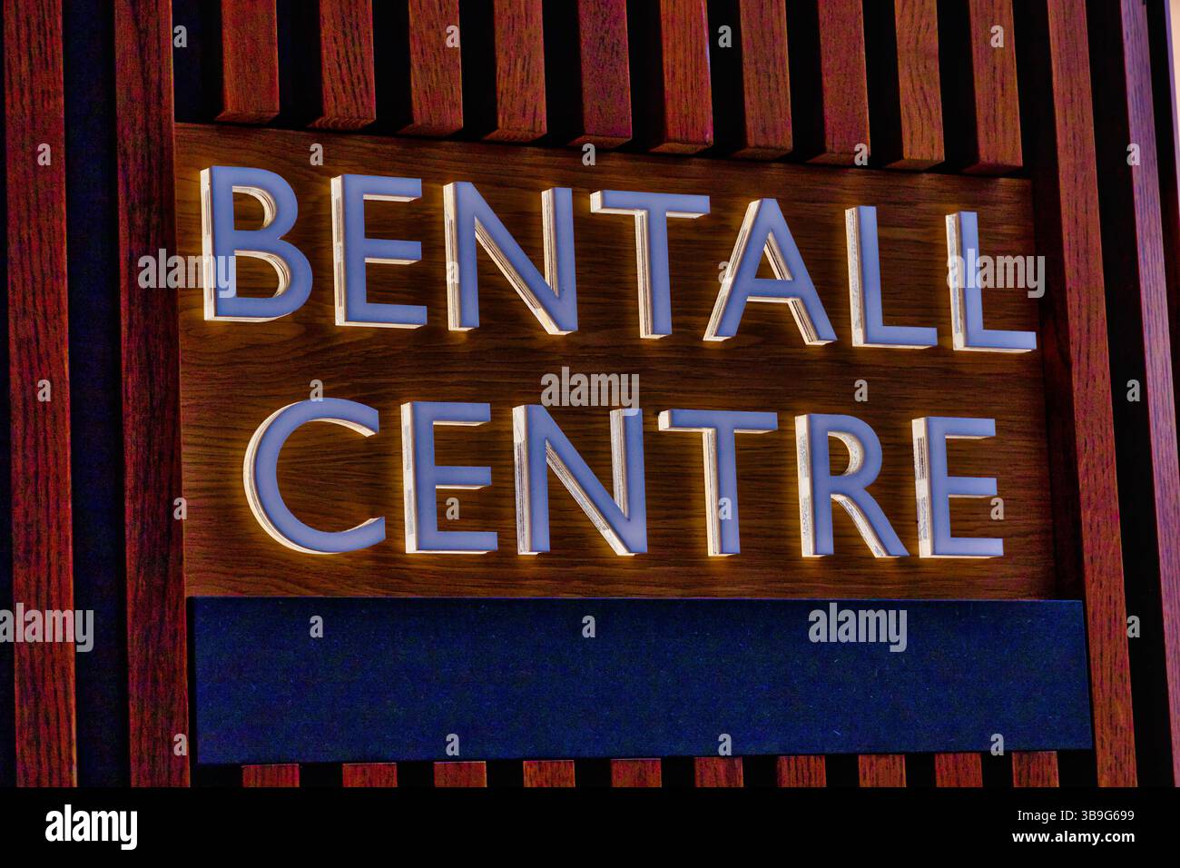 Illuminated "BENTALL CENTRE" sign mounted on a wooden panel with ...