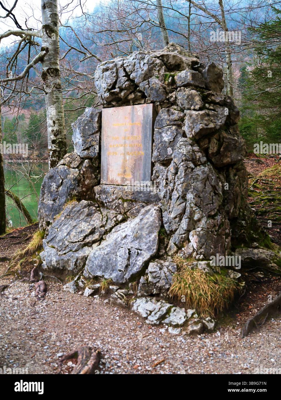 Historical stone monument surrounded by nature by a tranquil lake in ...