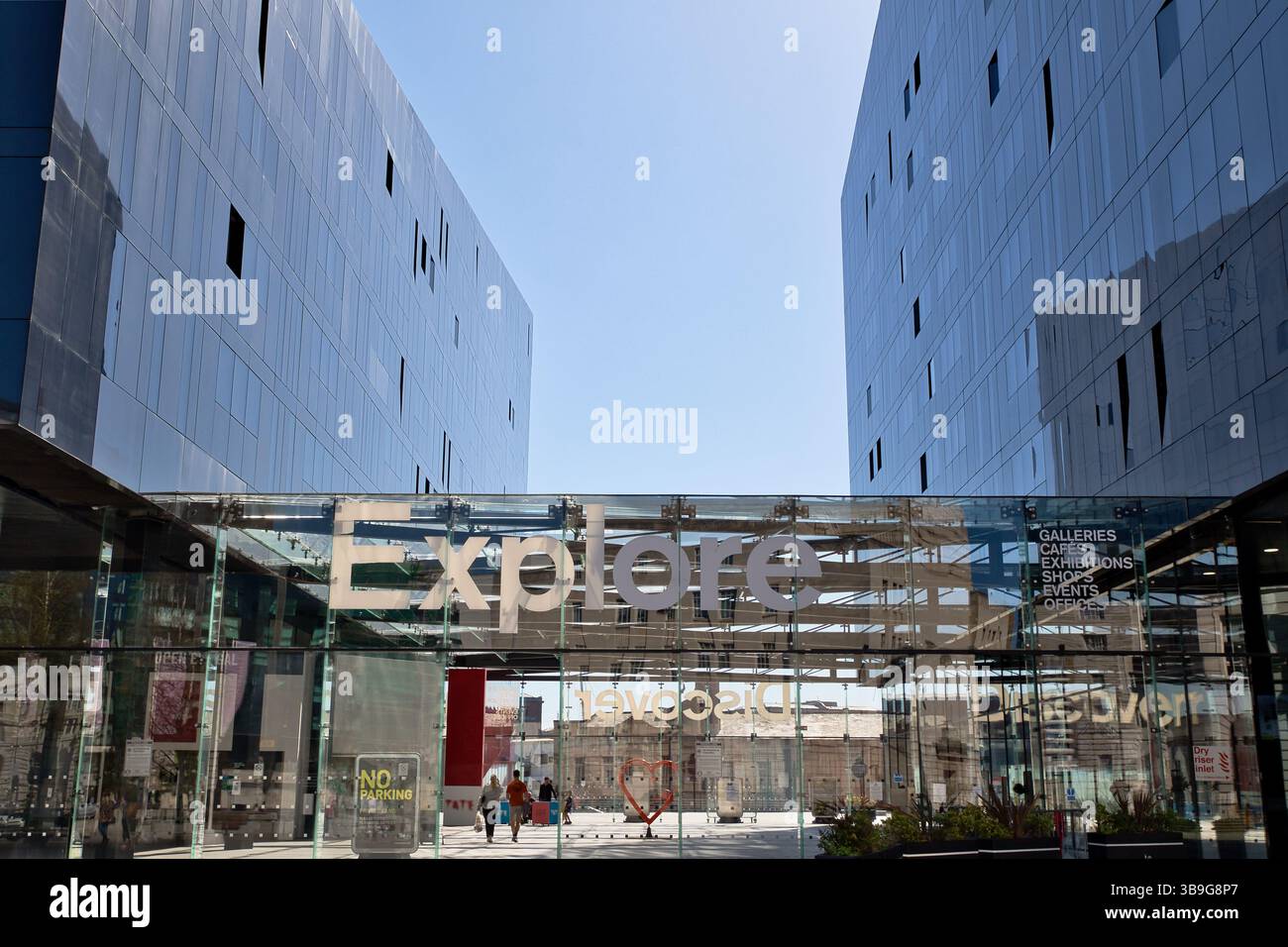 Exterior view of two modern buildings flanking a glass entrance with ...
